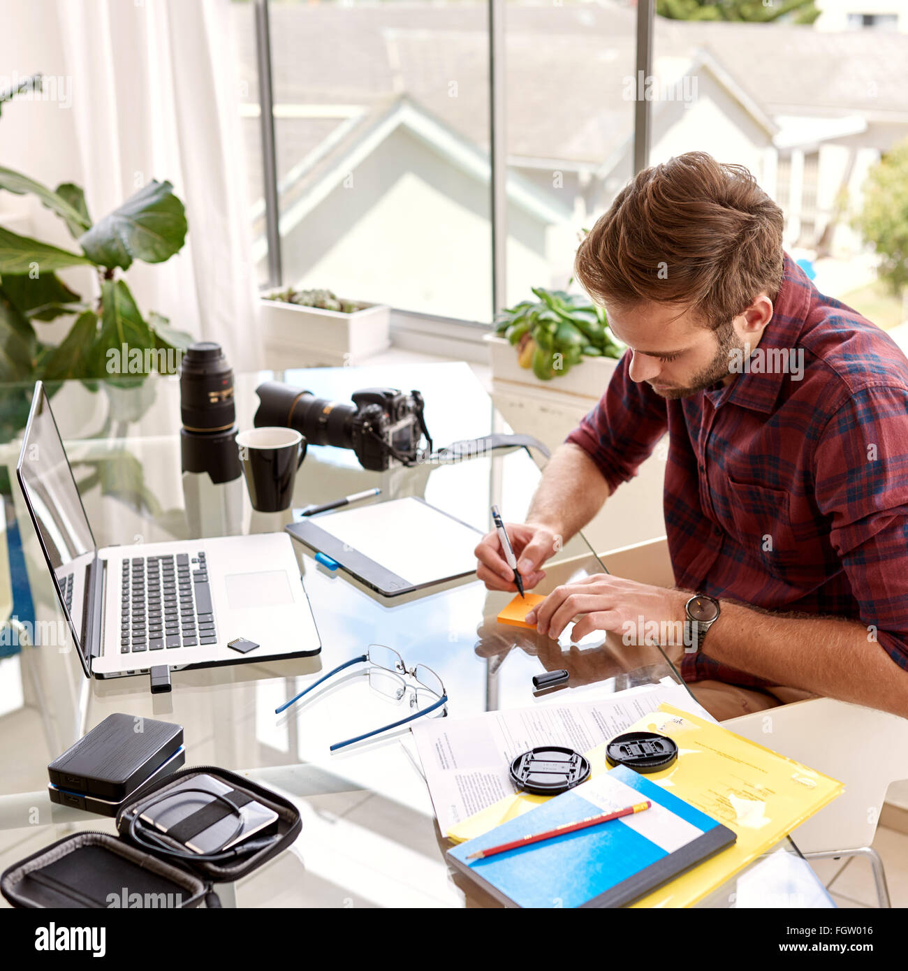 Square crop image of an entrepreneur busy working Stock Photo - Alamy