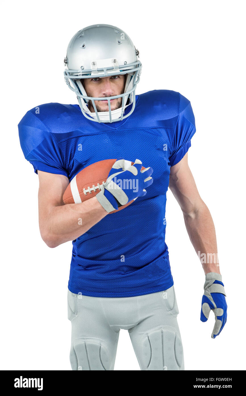 Portrait of confident American football player holding ball Stock Photo ...