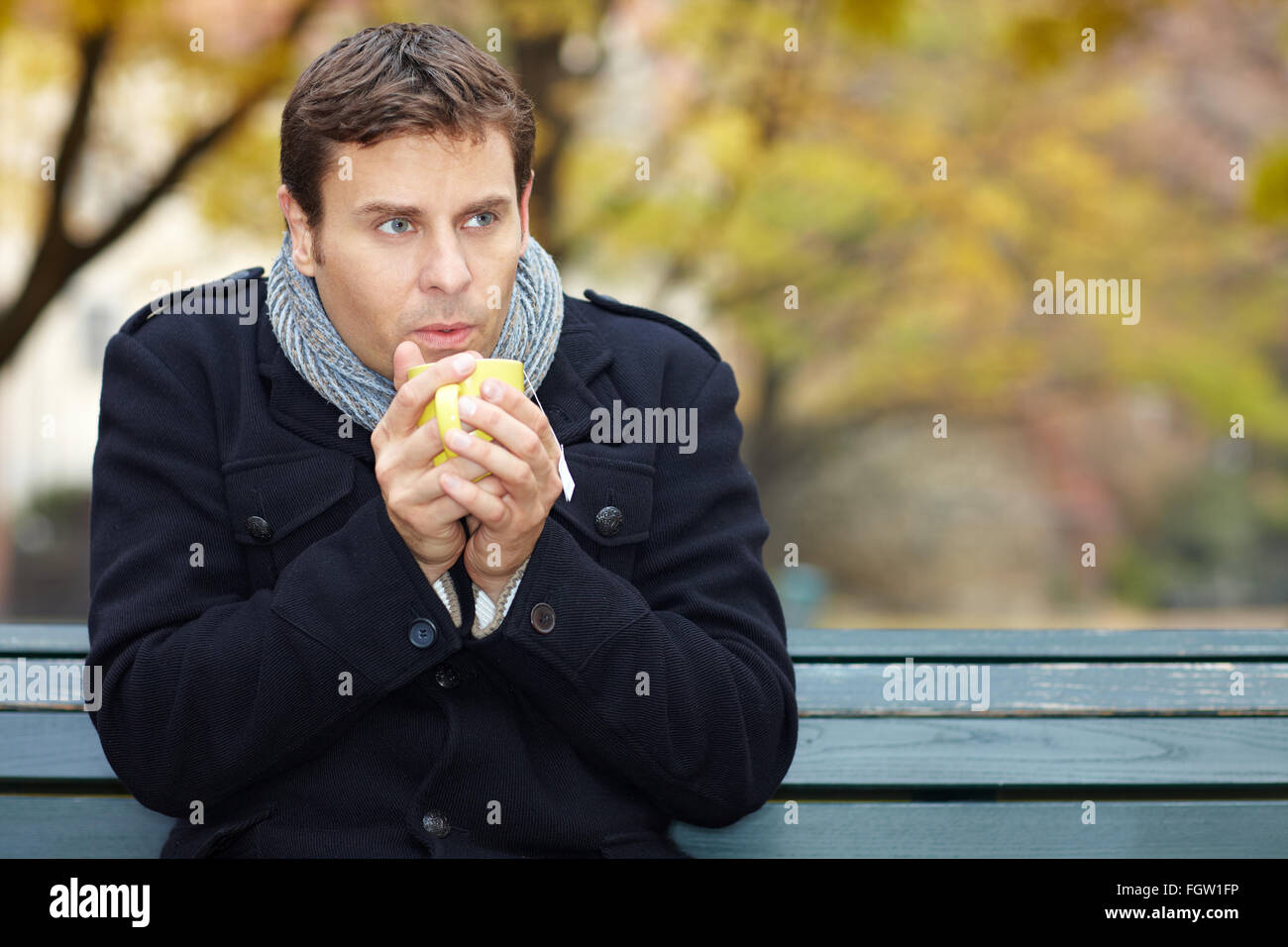 Shivering man in autumn drinks a cup of tea Stock Photo - Alamy