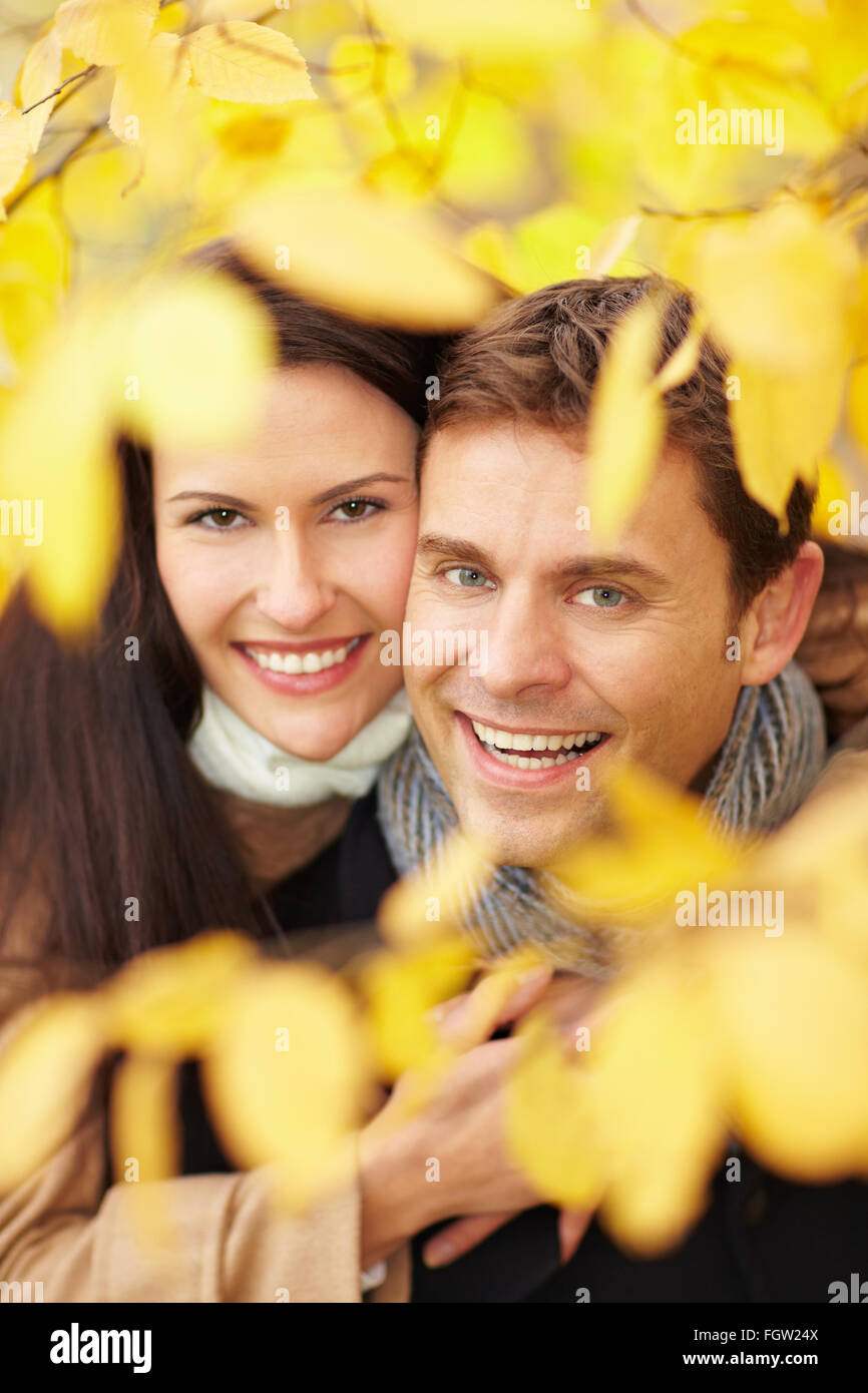 Happy smiling couple in a fall forest with yellow leaves Stock Photo ...