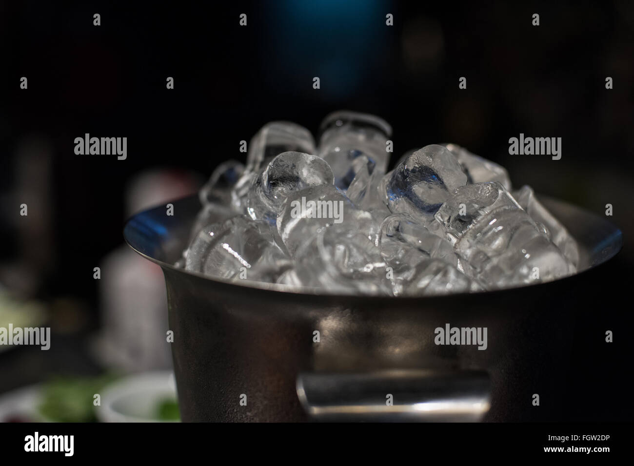 Ice bucket filled with ice cubes closeup Stock Photo - Alamy