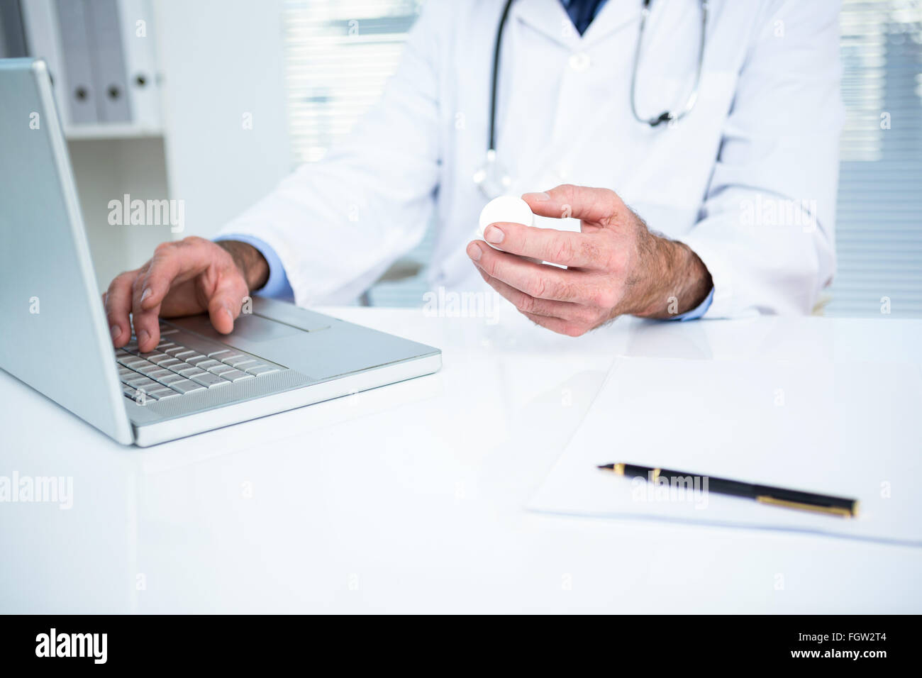 Doctor using laptop at clinic Stock Photo - Alamy