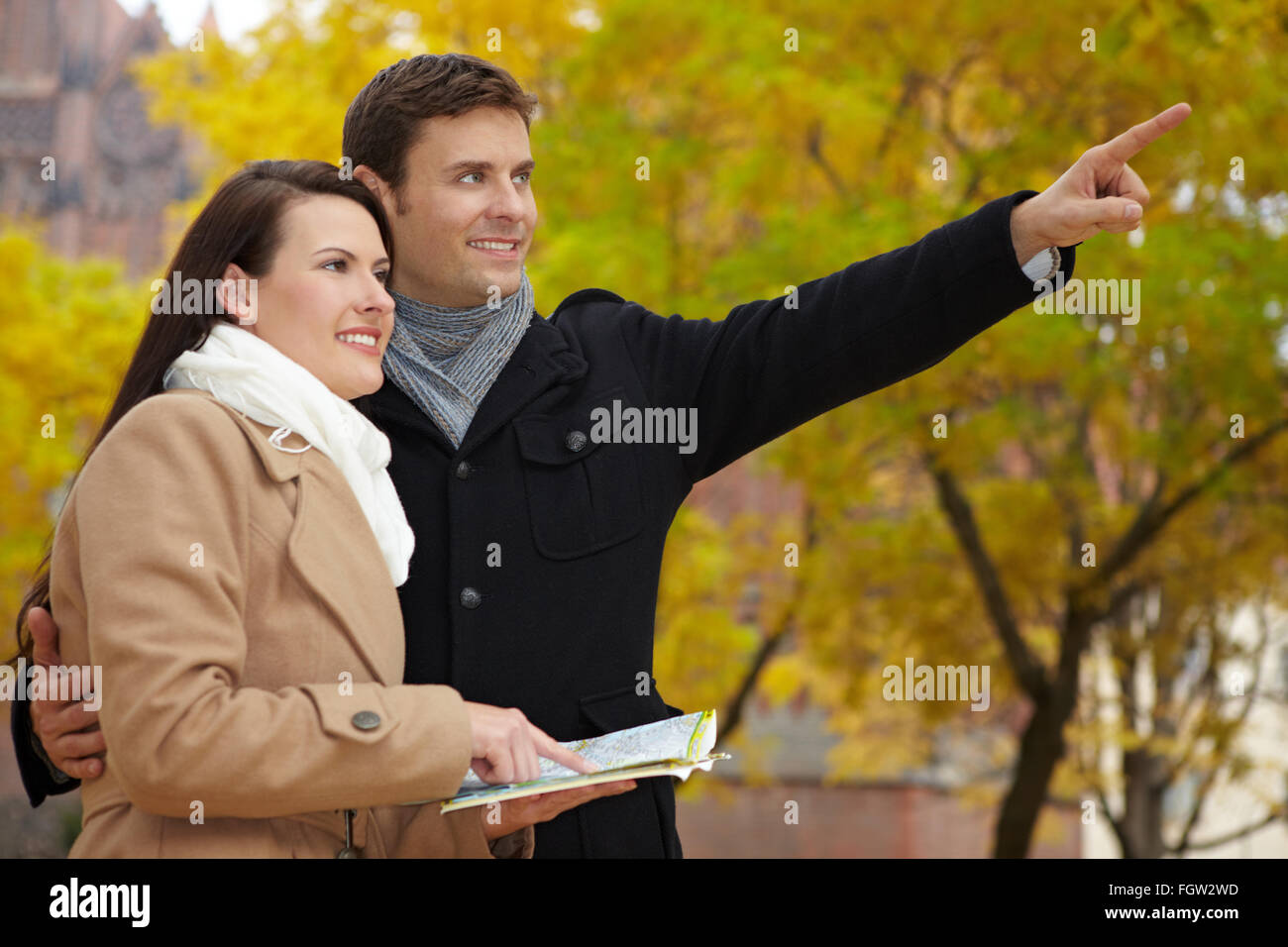 Tourists on holiday in autumn using city map for navigation Stock Photo ...
