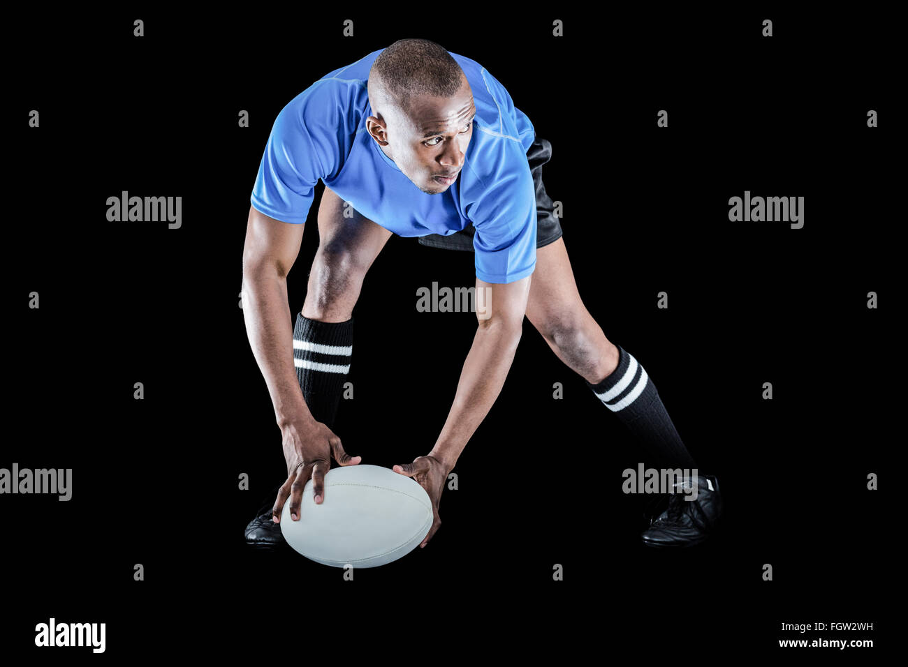Rugby player holding ball while playing Stock Photo - Alamy