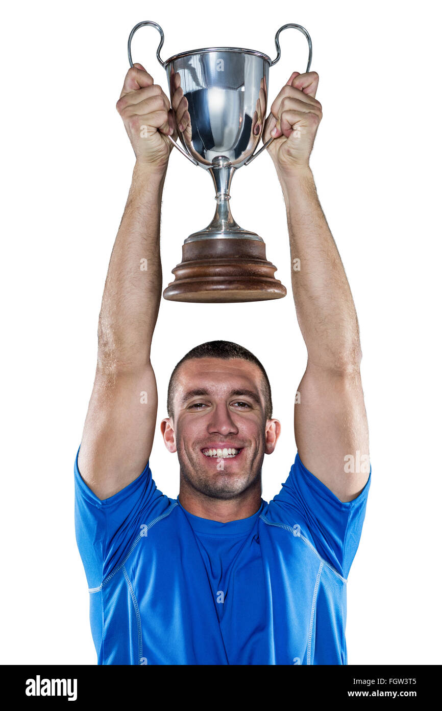 Portrait of smiling rugby player holding trophy Stock Photo - Alamy