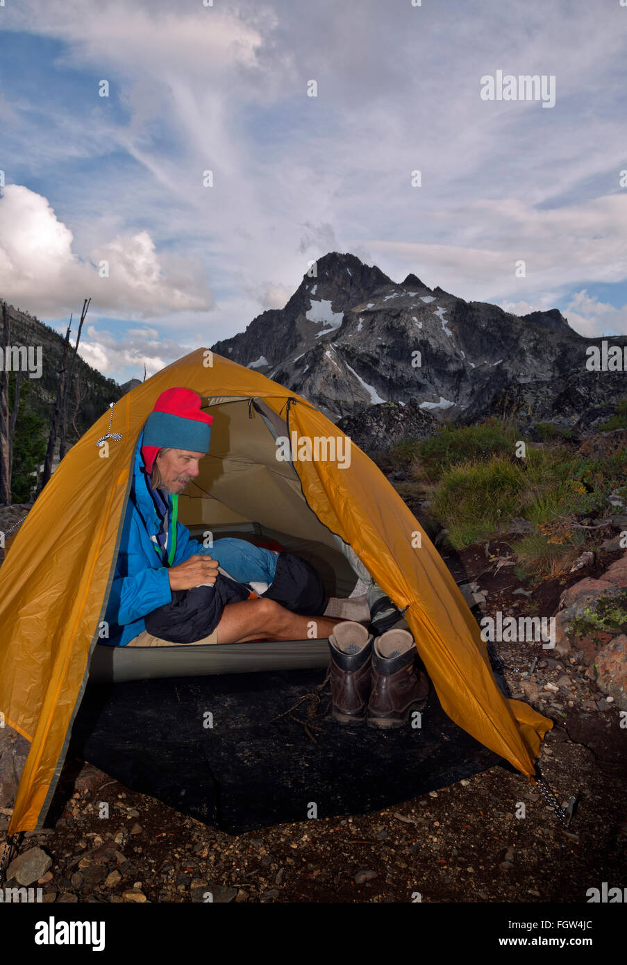 IDAHO - Hiker setting up camp at scenic campsite above Sawtooth Lake ...