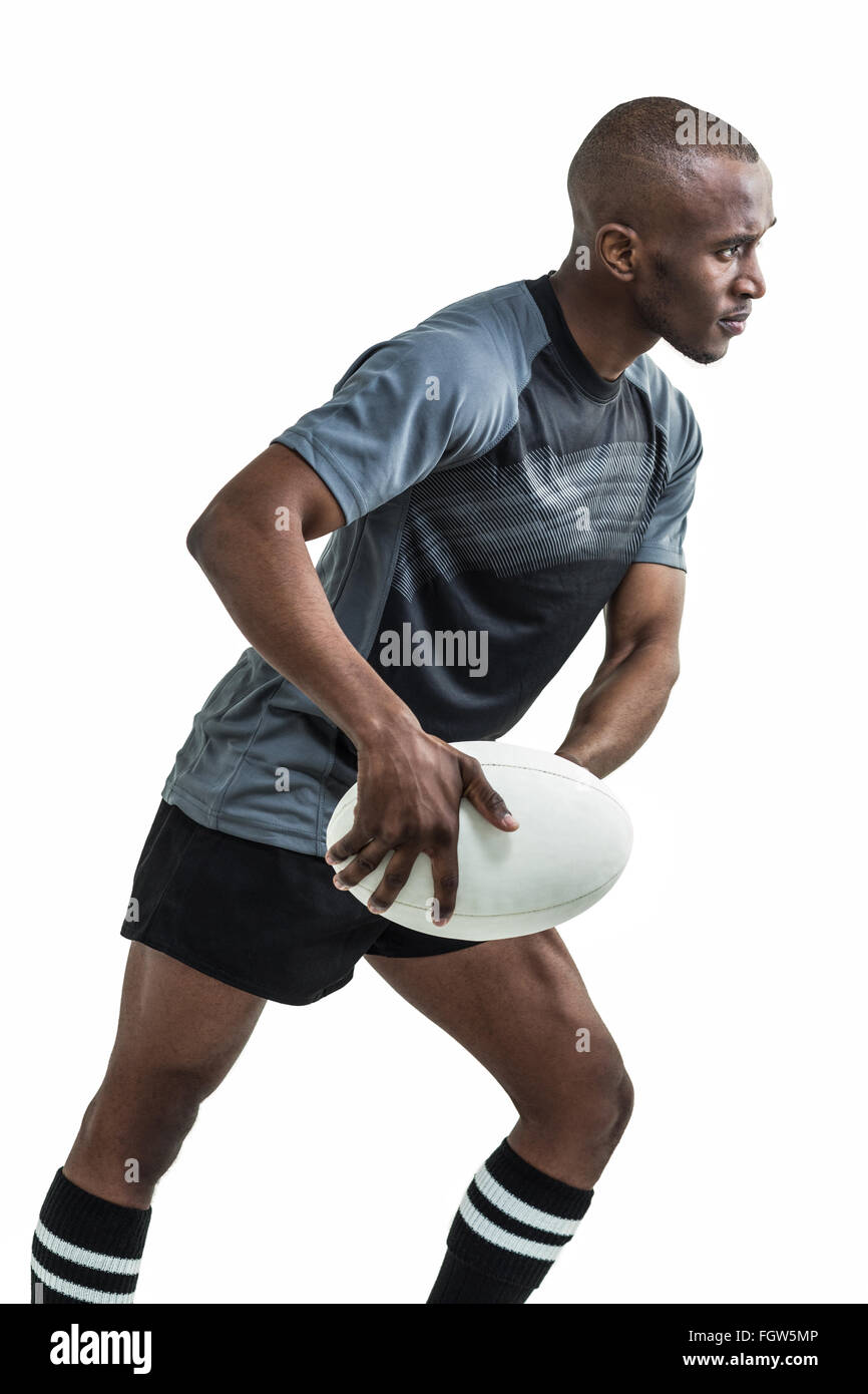 Sportsman throwing rugby ball Stock Photo - Alamy
