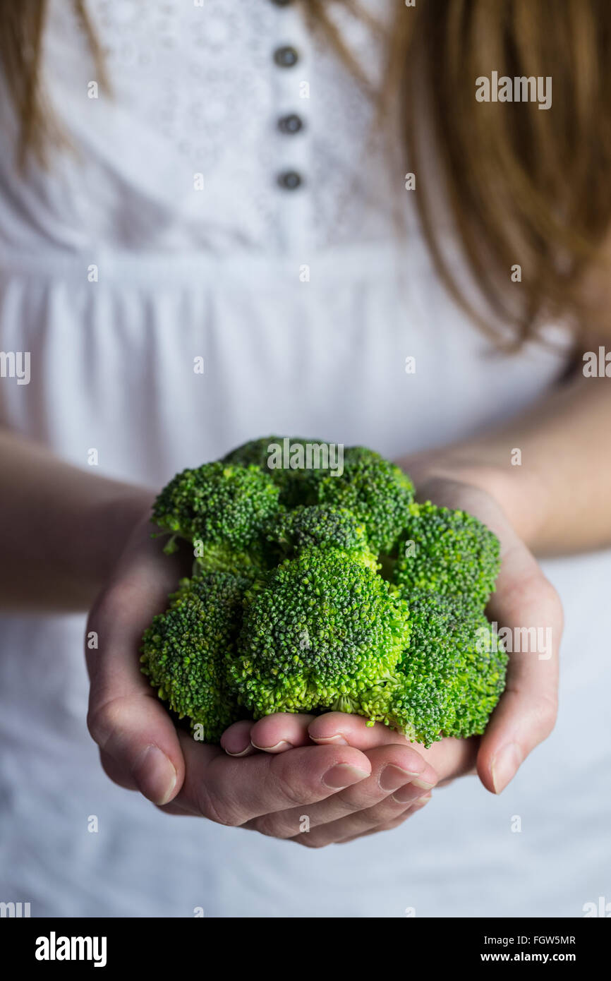 Woman showing fresh green brocolli hi-res stock photography and images ...