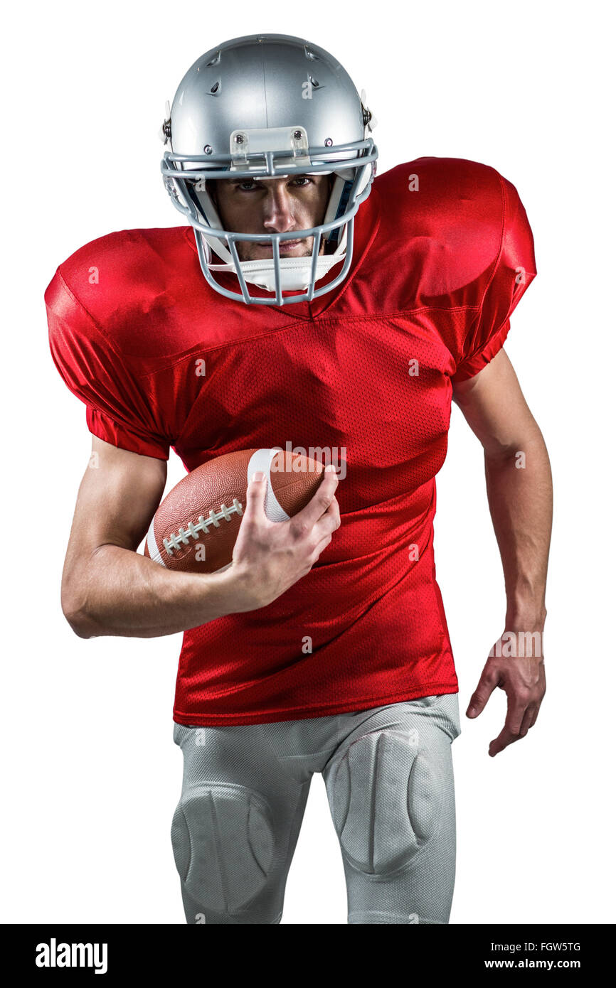 Portrait of American football player in red jersey running with ball ...