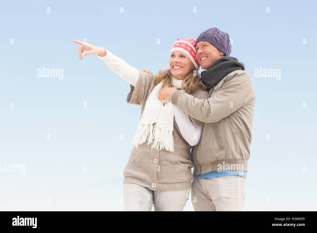 Happy couple standing holding each other Stock Photo - Alamy