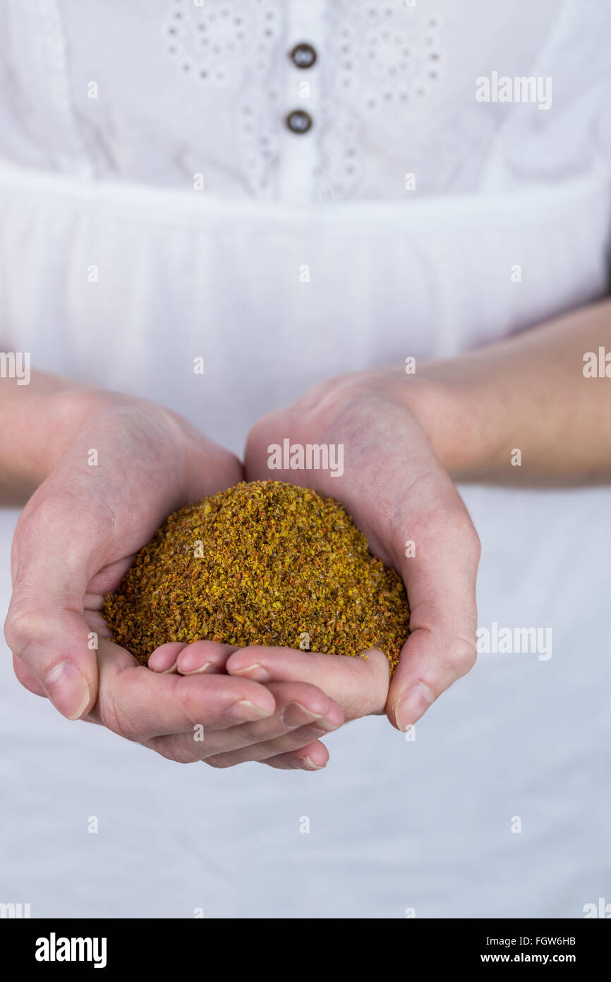 Woman showing handful of milled seed Stock Photo - Alamy