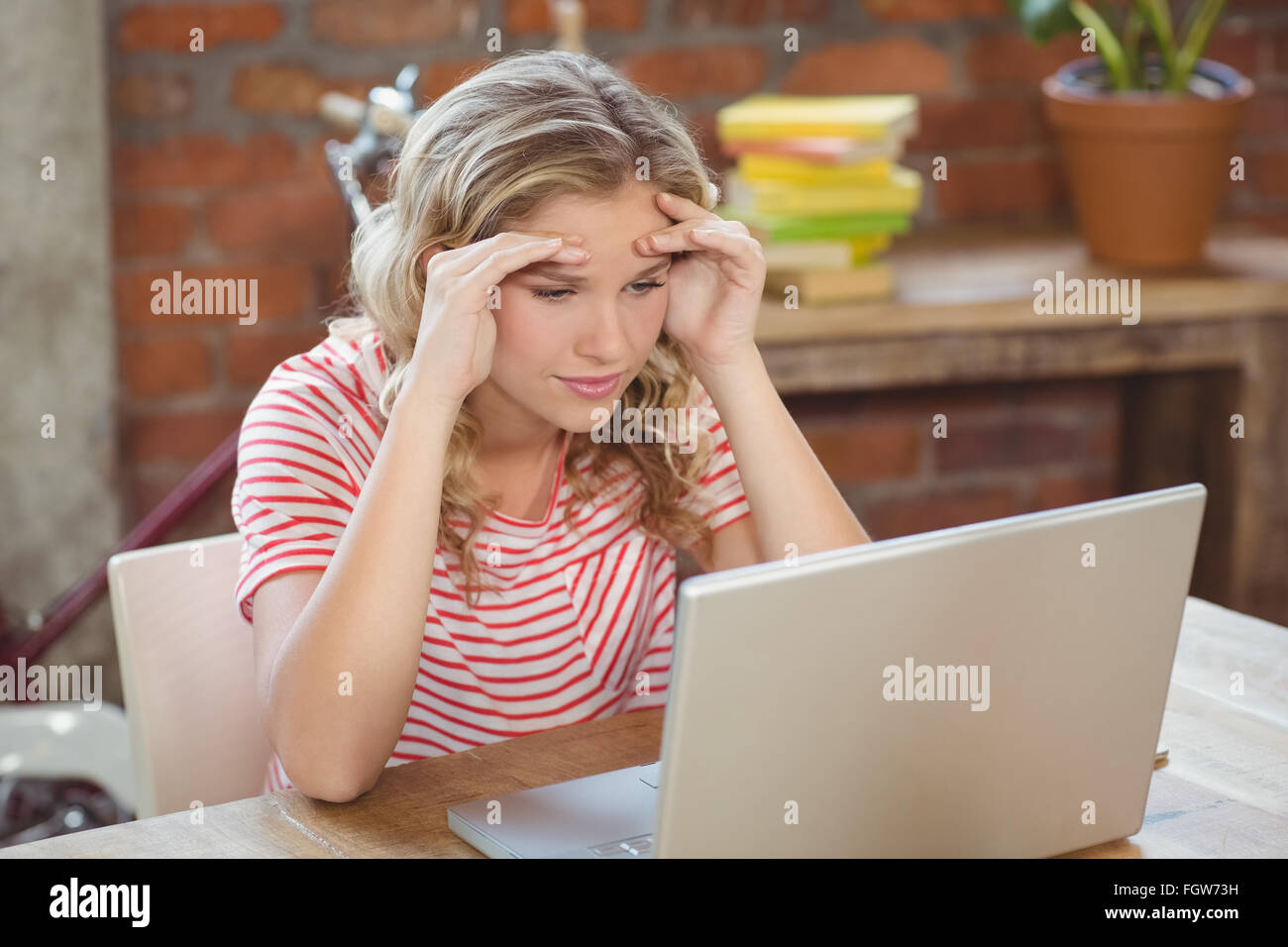 Stressed businesswoman working in creative office Stock Photo - Alamy