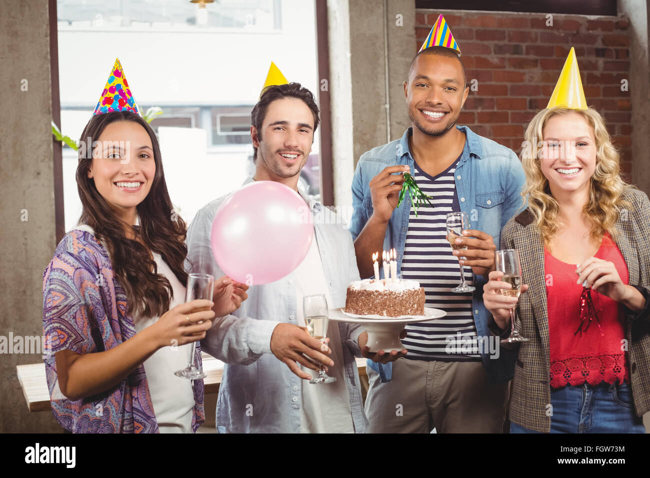 Portrait of casual business people celebrating birthday in office Stock ...
