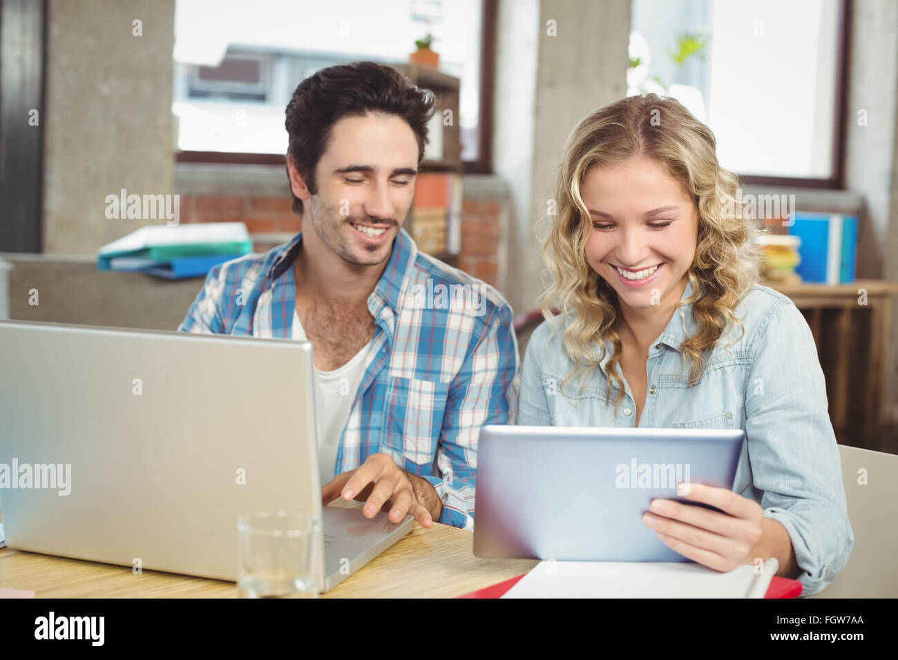 Colleagues smiling and working Stock Photo - Alamy