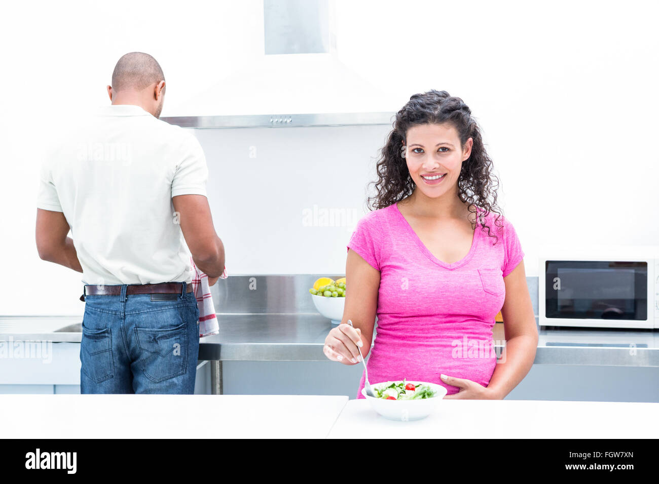Portrait of happy wife with husband helping in kitchen Stock Photo - Alamy