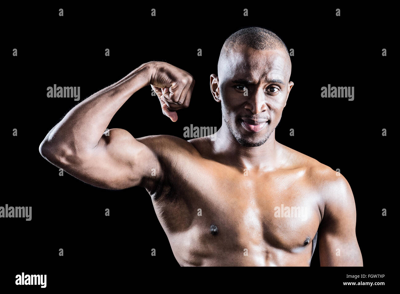 Portrait of muscular man smiling while flexing muscles Stock Photo - Alamy