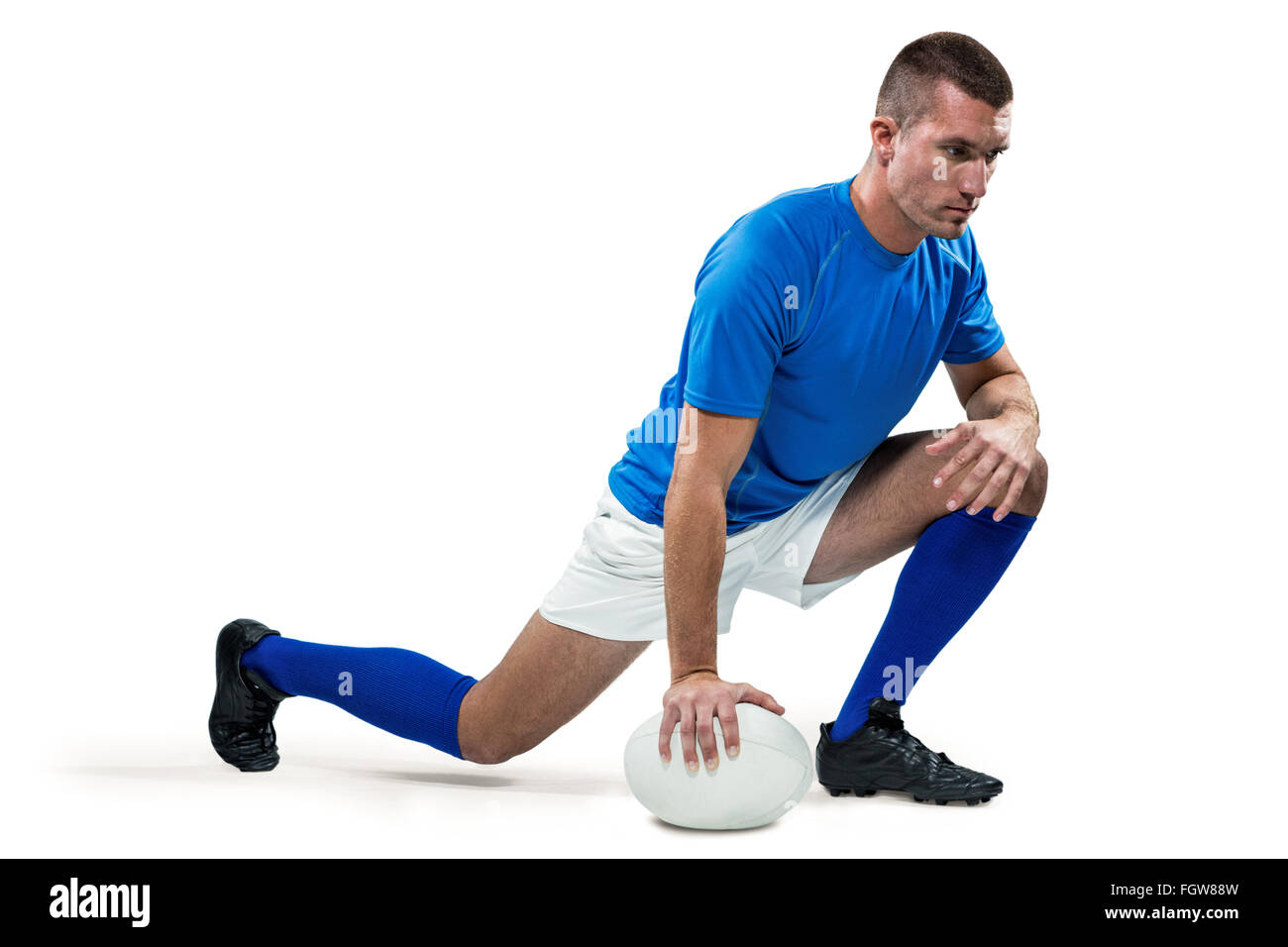 Rugby player stretching with ball Stock Photo - Alamy