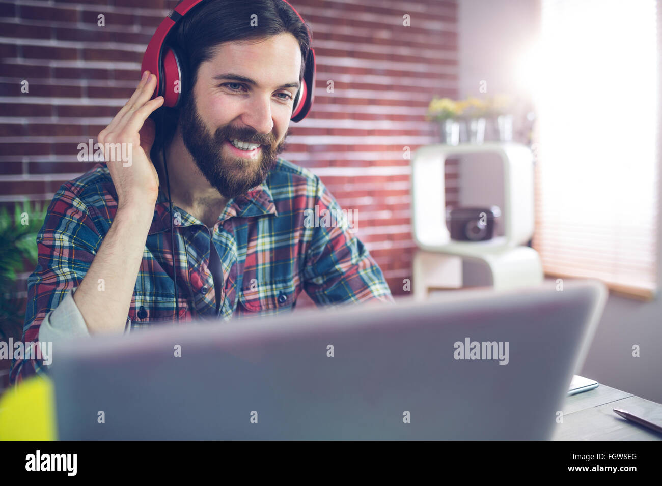 Happy businessman listening music at office Stock Photo - Alamy