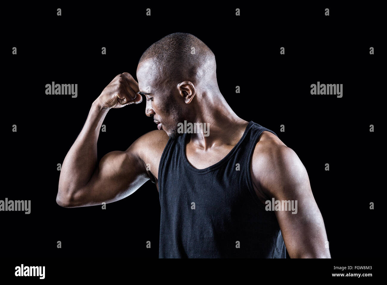 Athlete looking at bicep while flexing muscles Stock Photo - Alamy