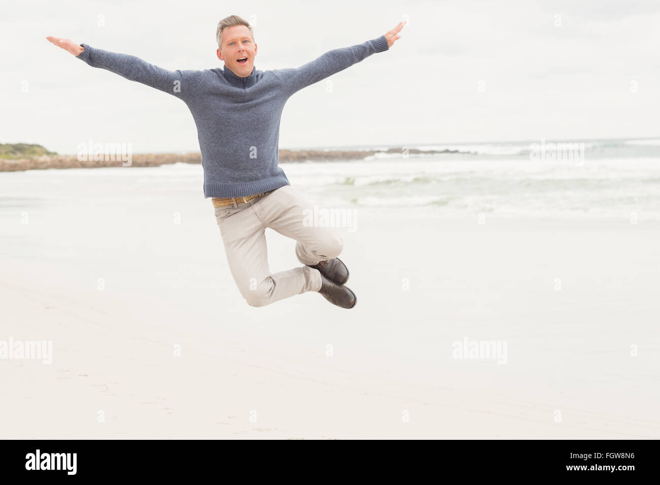 Man standing with arms out wide Stock Photo - Alamy