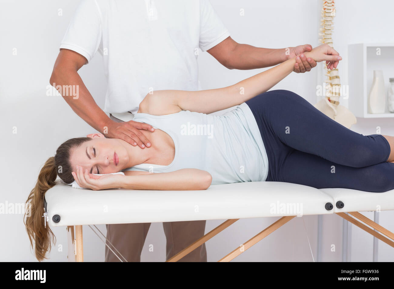 Doctor stretching his patient arm Stock Photo - Alamy