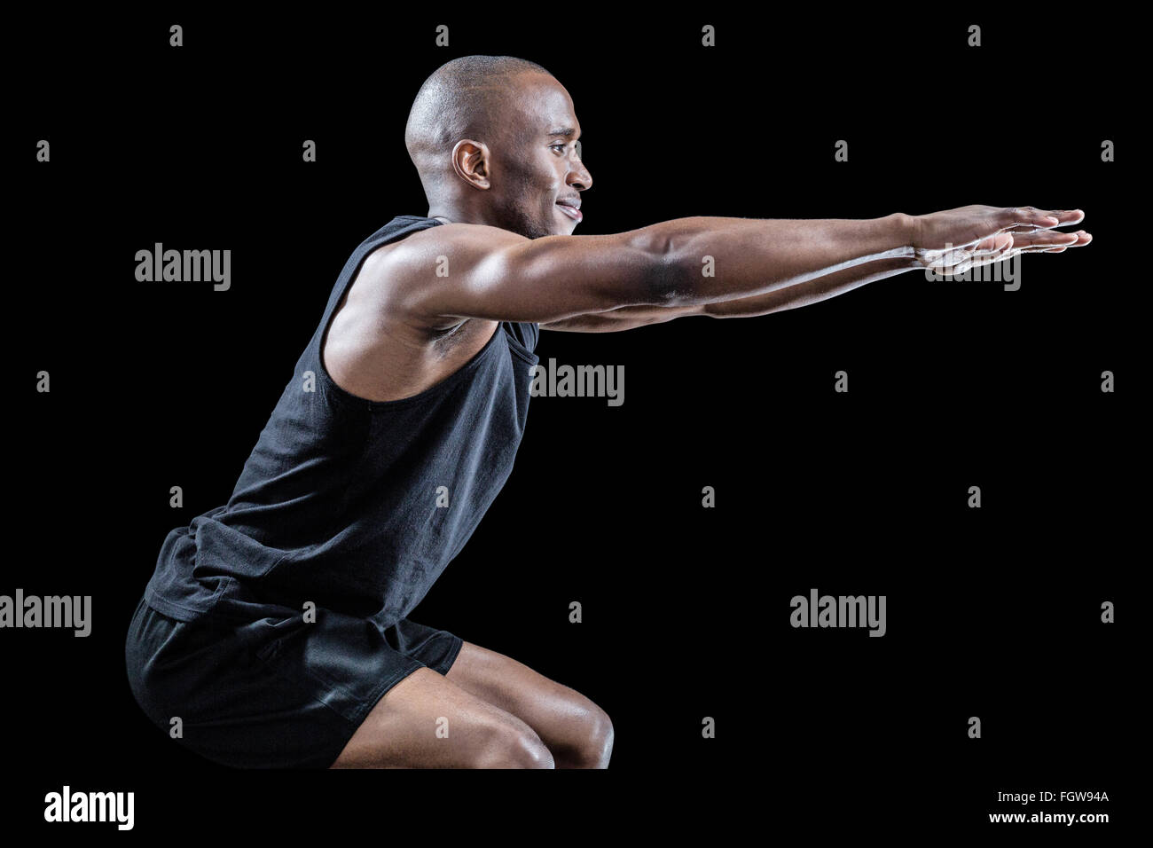 Side view of sportsman squatting Stock Photo - Alamy