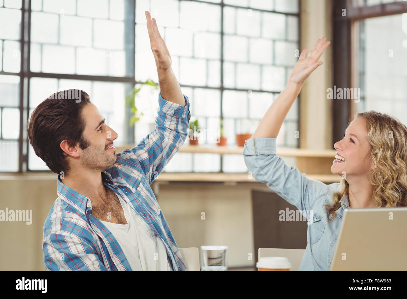 Colleagues giving high five Stock Photo - Alamy