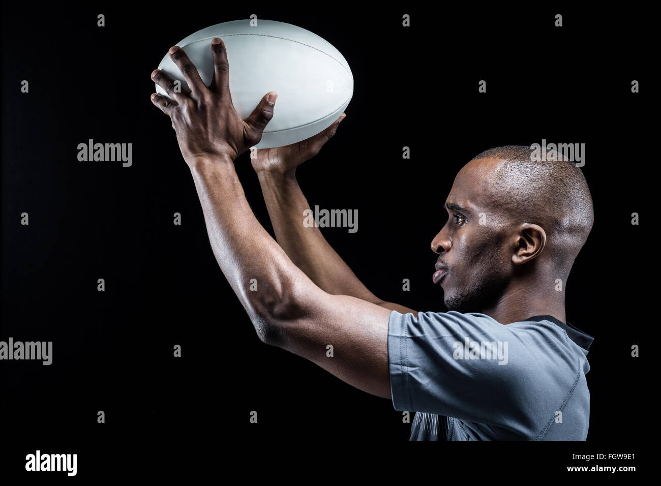 Athlete in position of throwing rugby ball Stock Photo - Alamy