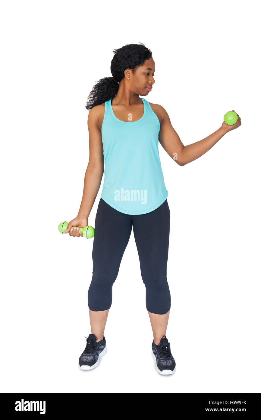 Woman exercising using dumbbells Stock Photo - Alamy