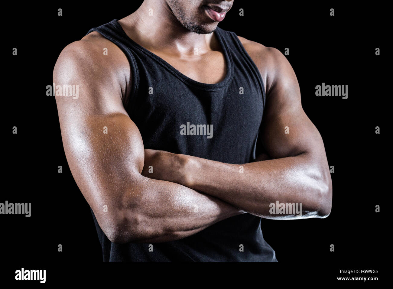 Mid section of muscular man with arms crossed Stock Photo - Alamy