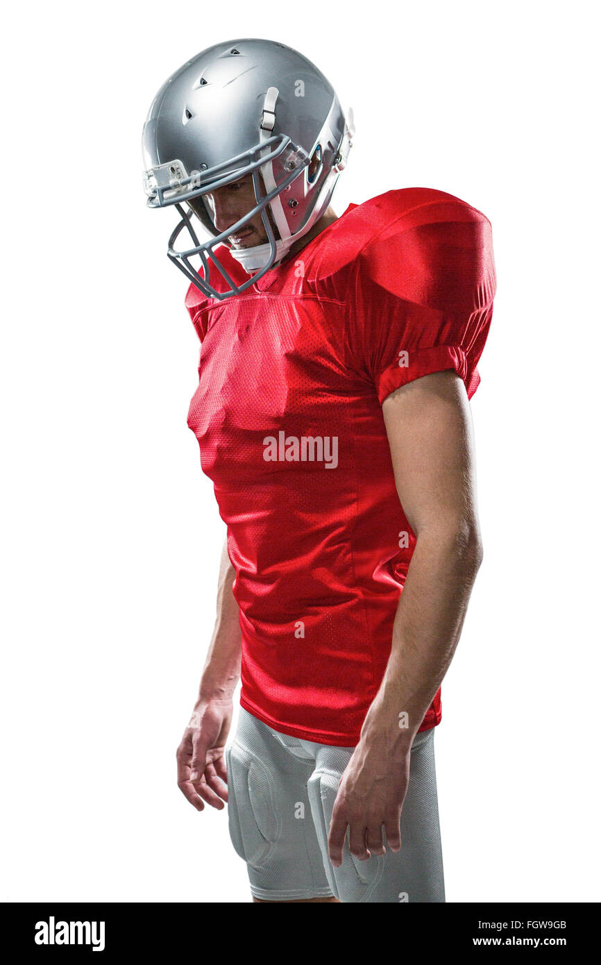 American football player in red jersey looking down Stock Photo - Alamy