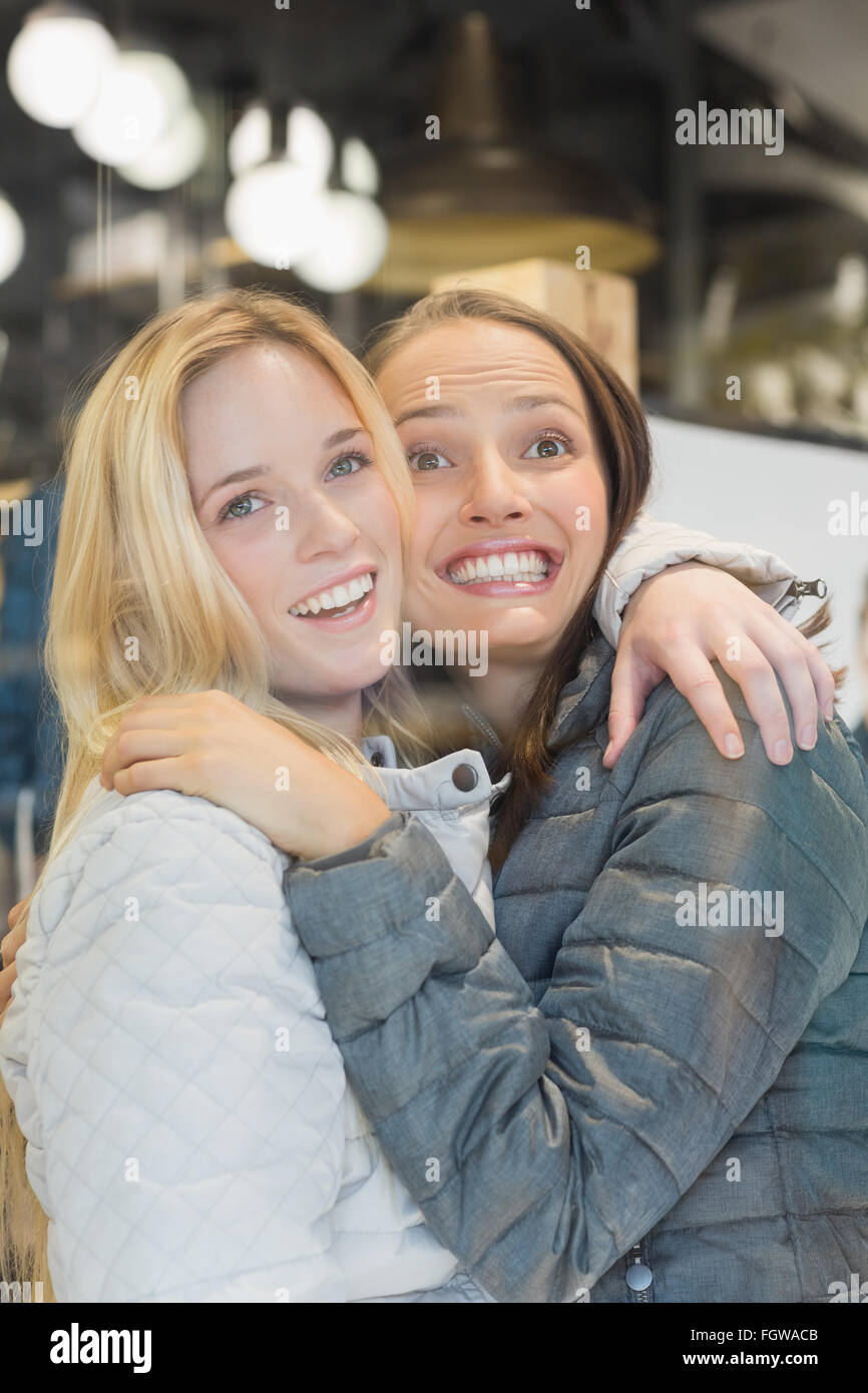 Two female friends embracing Stock Photo - Alamy