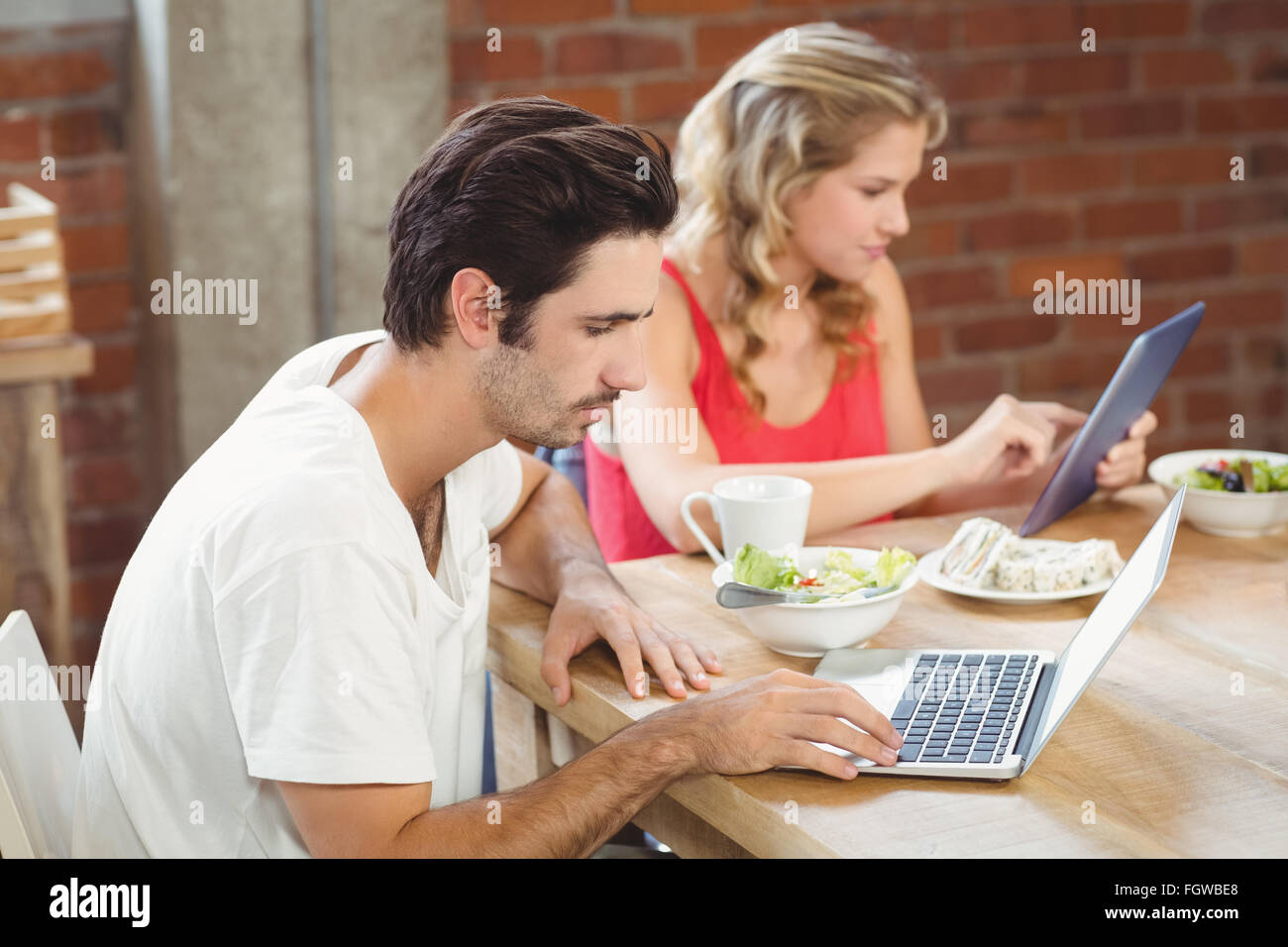 Colleagues using technologies in office Stock Photo - Alamy