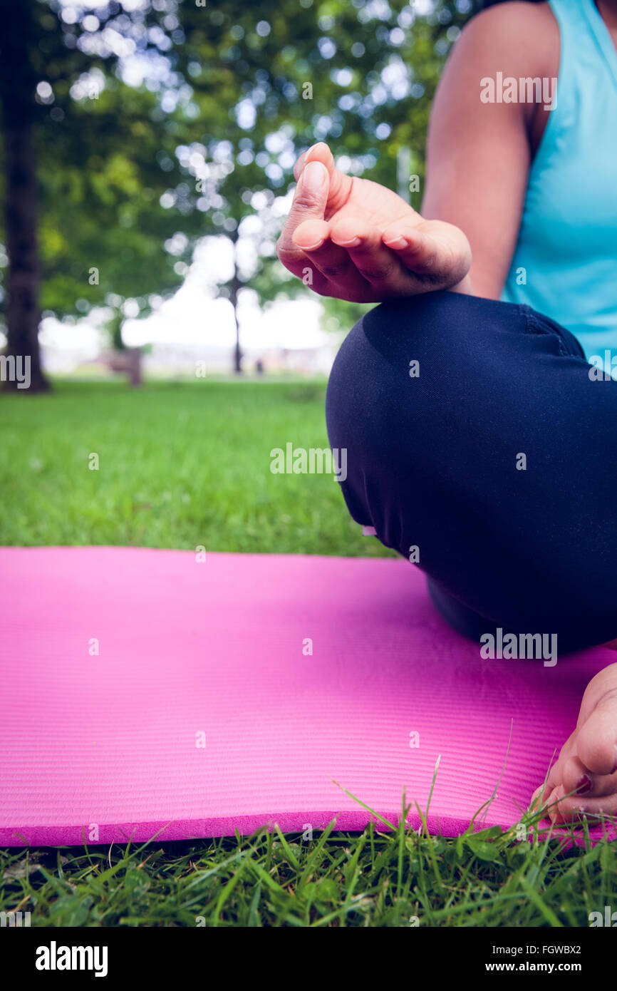 Young woman doing yoga on mat Stock Photo - Alamy