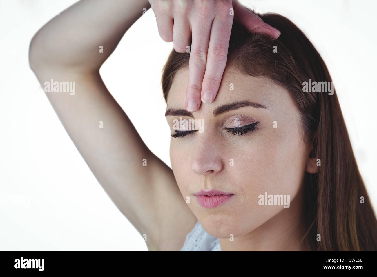 Woman meditating with hand on forehead Stock Photo - Alamy