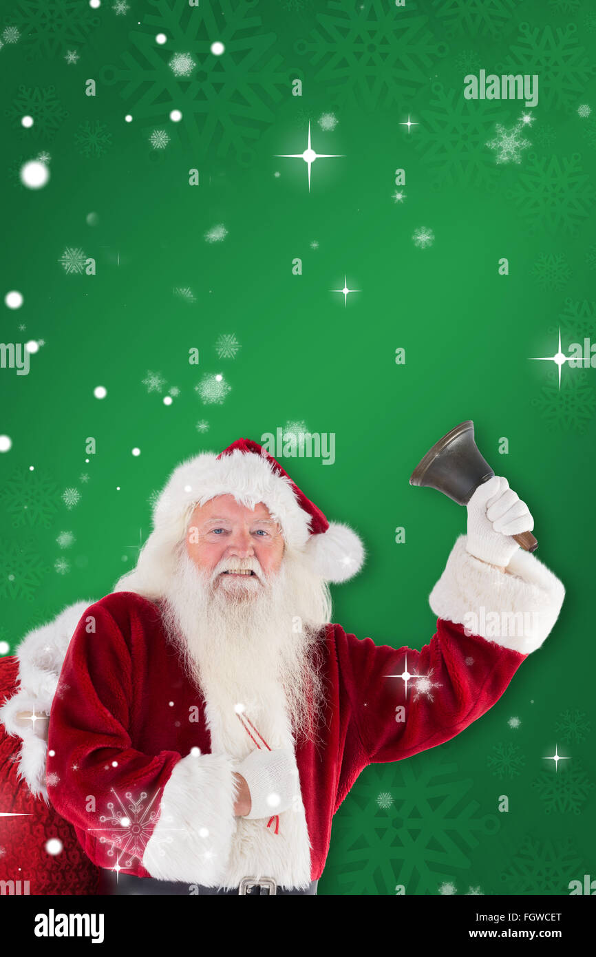 Composite image of happy santa ringing a bell Stock Photo - Alamy