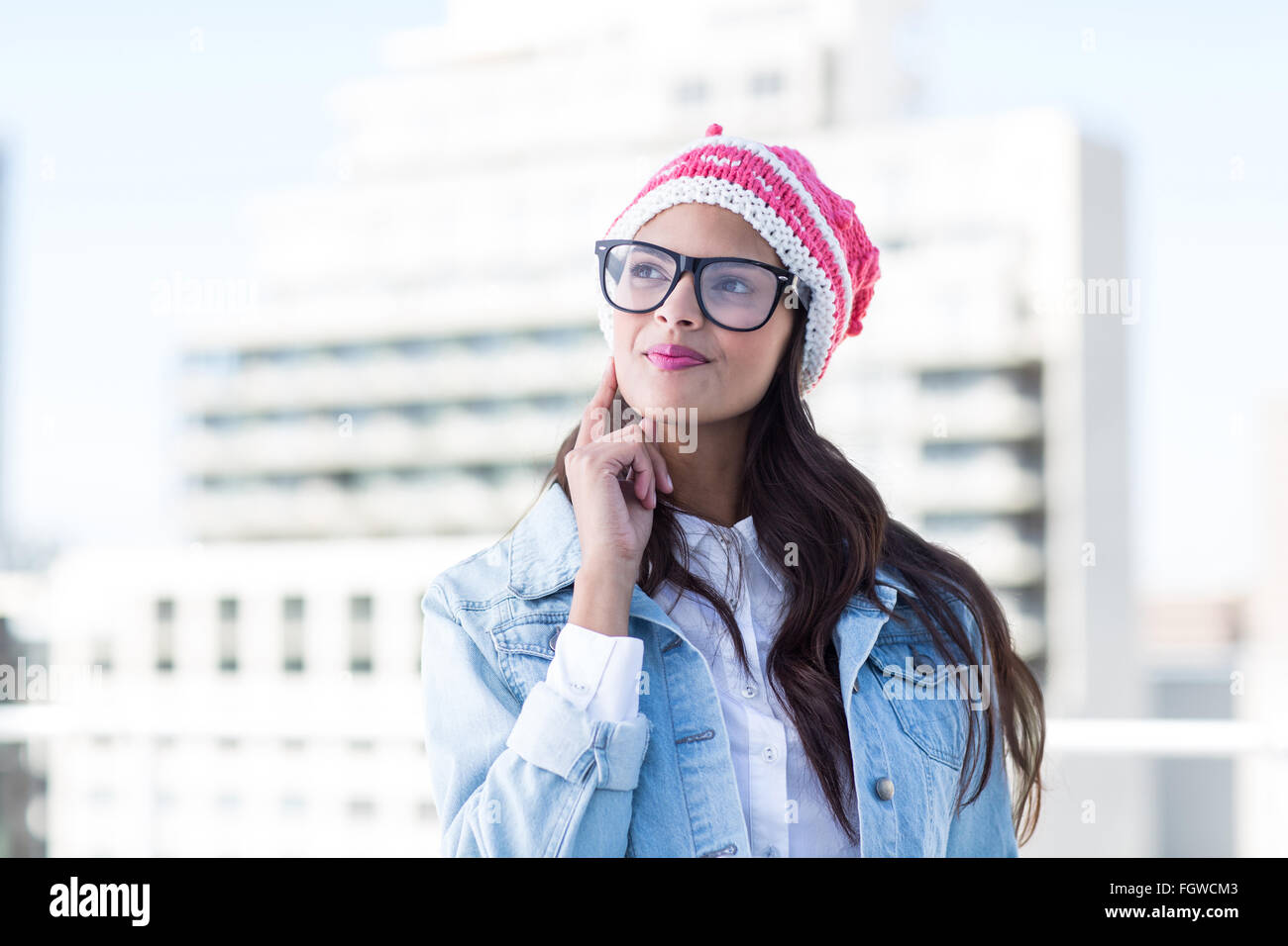 Thoughtful woman looking up with finger on cheek Stock Photo - Alamy