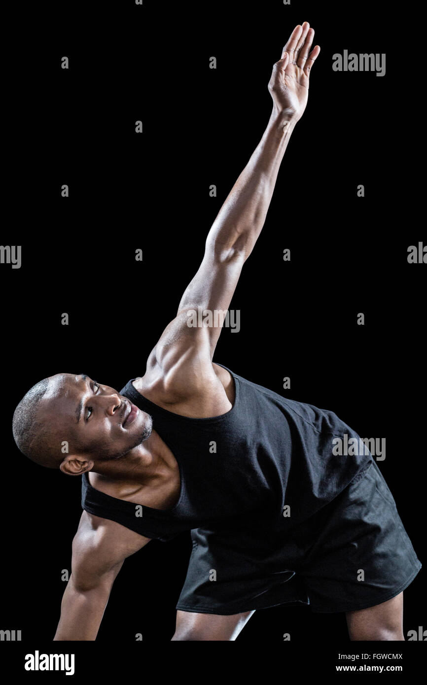 Sportsman bending while exercising Stock Photo - Alamy