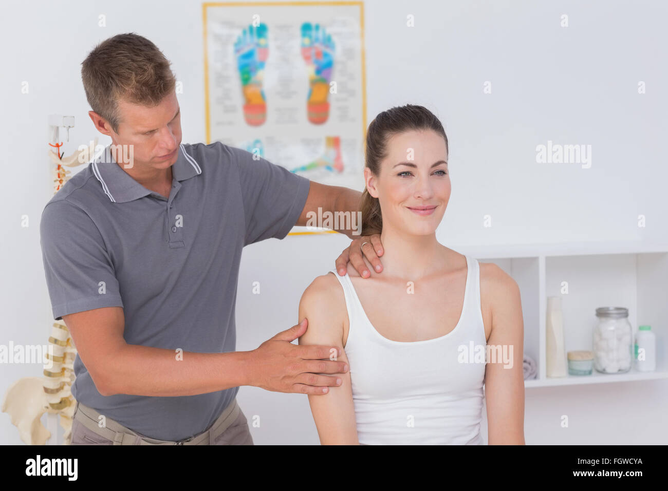Doctor stretching woman arm Stock Photo - Alamy