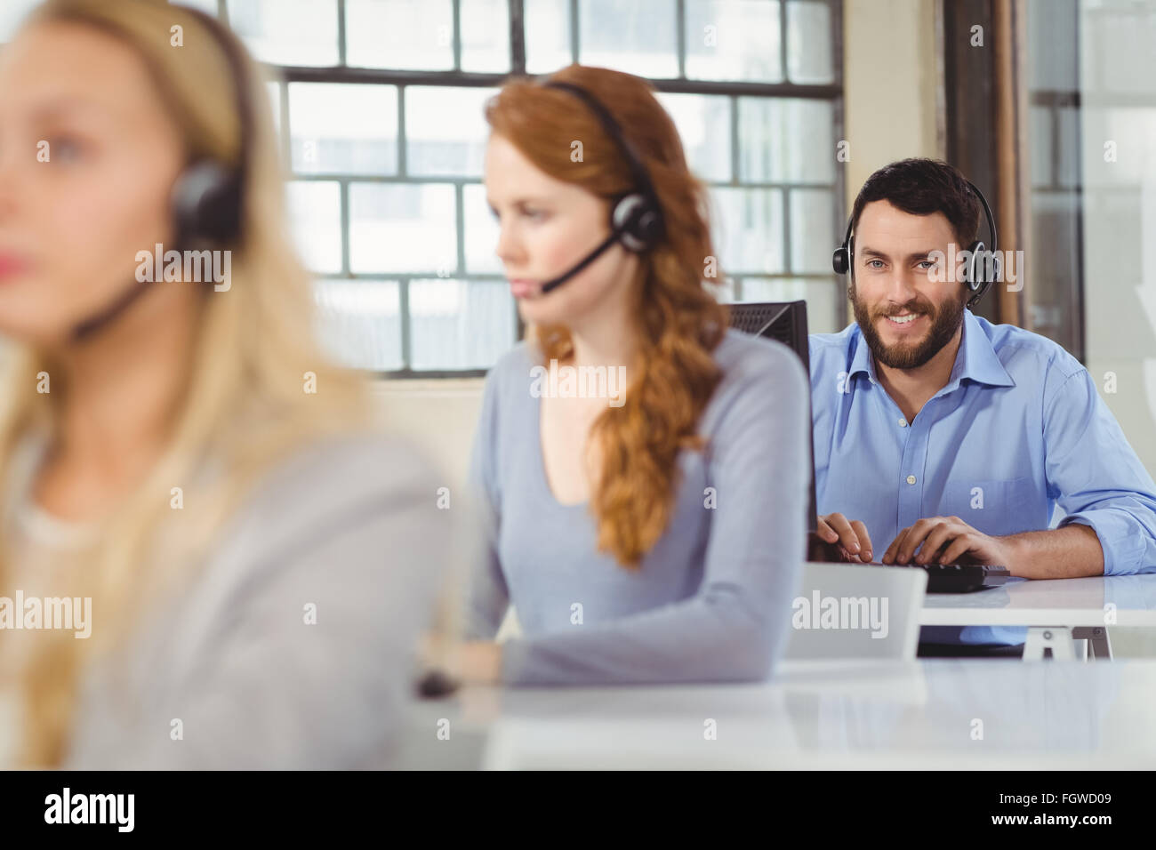 Portrait of young smiling operator Stock Photo - Alamy