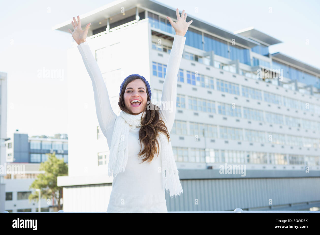 Happy brunette raising arms Stock Photo - Alamy