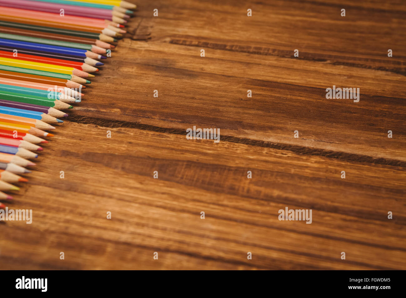 Colour pencils on desk with copy space Stock Photo - Alamy