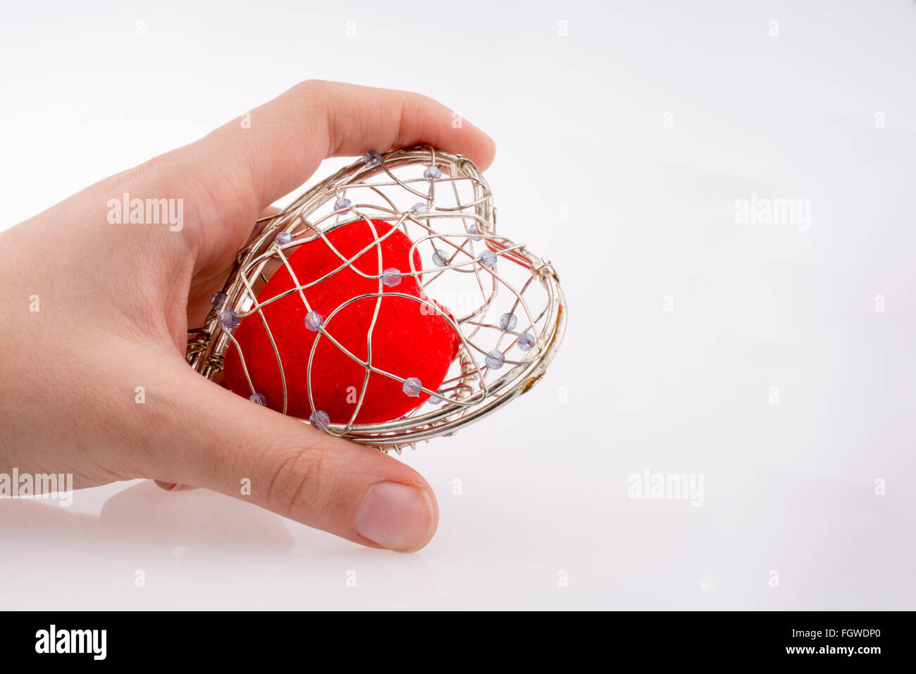 Red heart in a heart shaped cage Stock Photo - Alamy