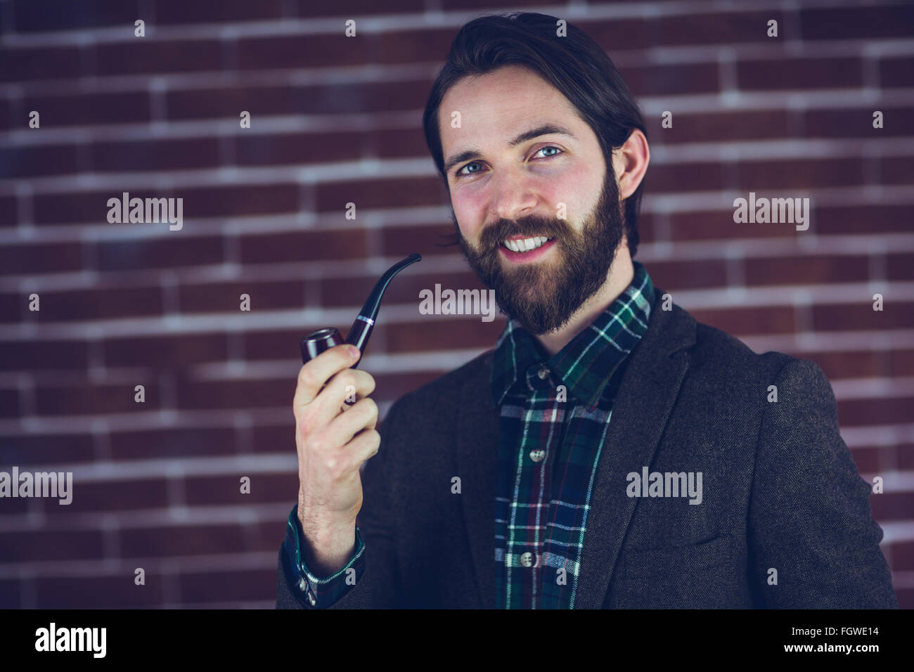 Portrait of smiling handsome man smoking pipe Stock Photo - Alamy