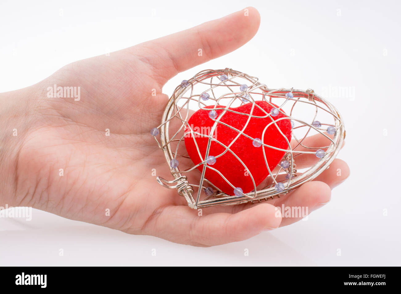 Red heart in a heart shaped cage Stock Photo - Alamy