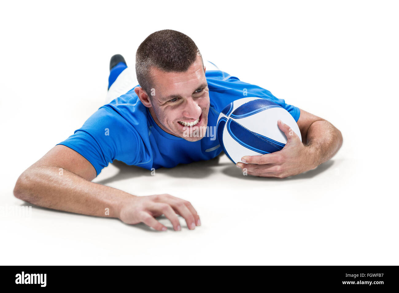 Confident rugby player lying in front with ball Stock Photo - Alamy