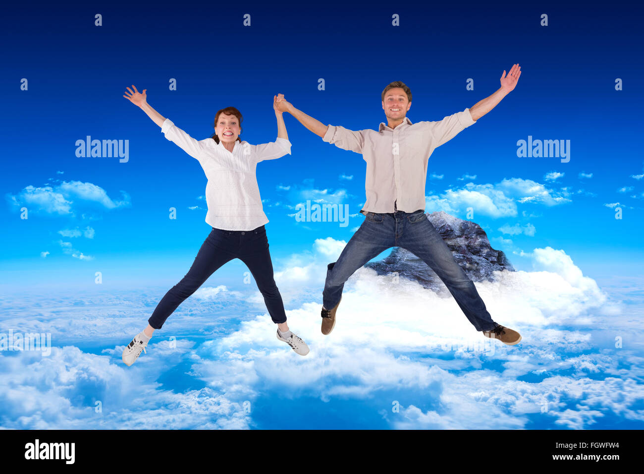 Composite image of couple jumping and holding hands Stock Photo - Alamy