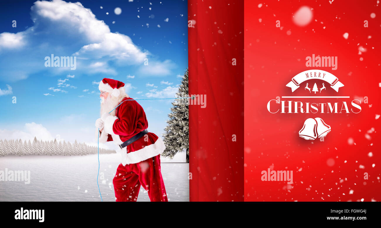 Composite image of santa claus pulling a rope Stock Photo - Alamy