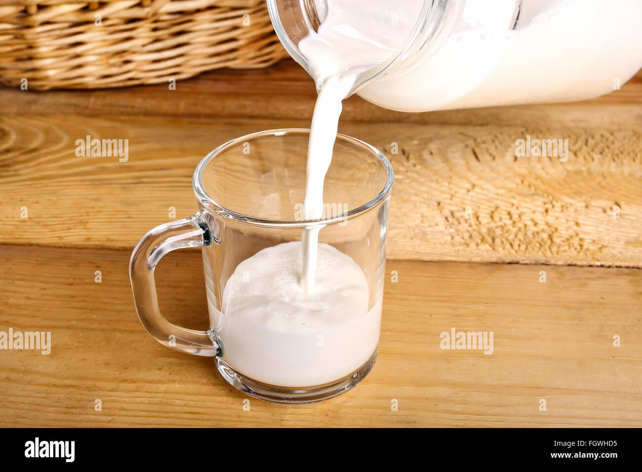 Milk poured into a glass from a bottle hi-res stock photography and ...