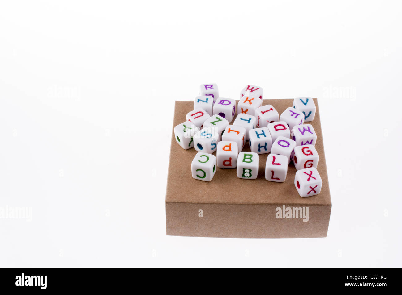 letter cubes placed on a box on a white background Stock Photo - Alamy